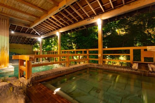 Watch the clear stream of Shima River from the giant open-air bath at ...