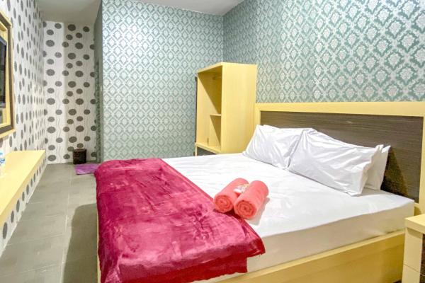 Tini's Guest House Malang Mitra Reddoorz - Malang